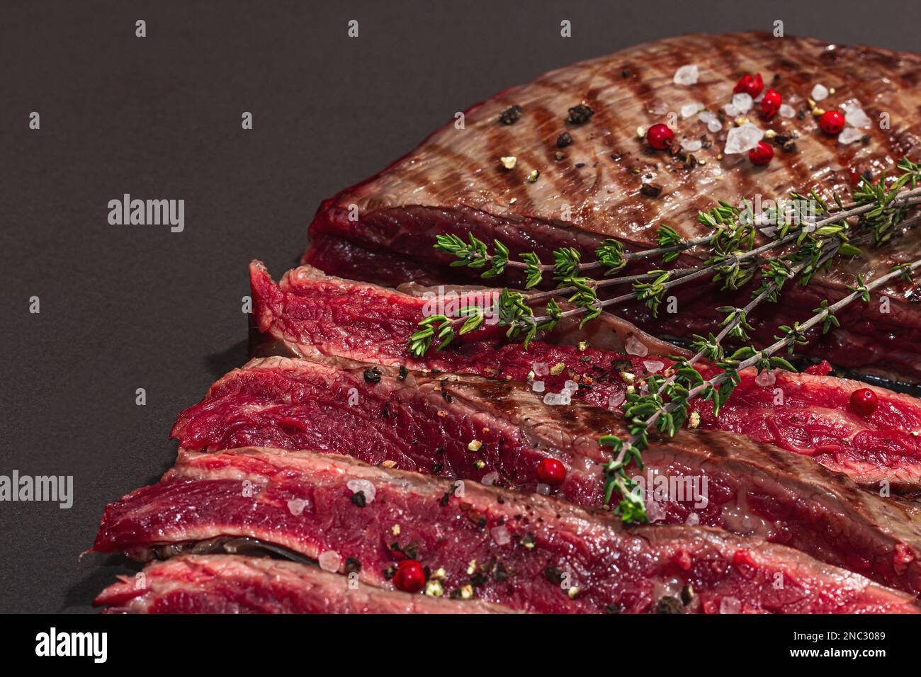 Medium rare Flank steak with spices and herbs. Classic grilled meat cut ...