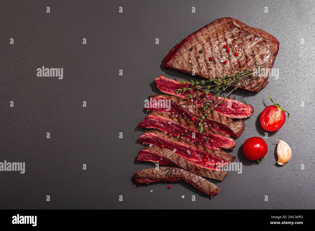 Medium rare Flank steak with spices and herbs. Classic grilled meat cut ...