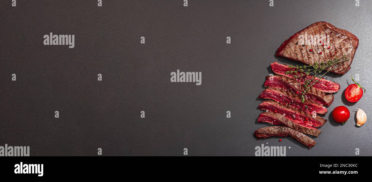 Medium rare Flank steak with spices and herbs. Classic grilled meat cut ...