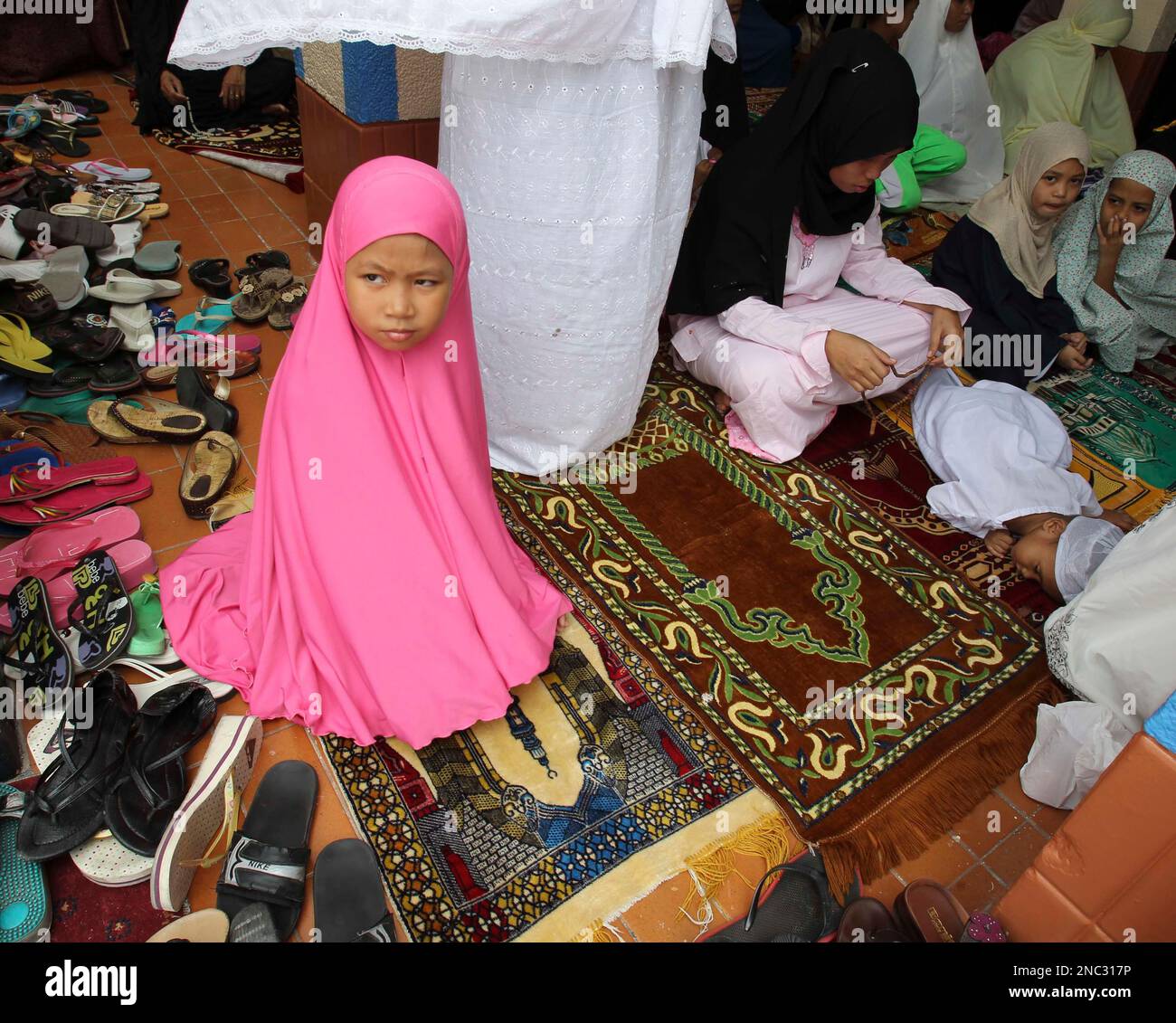 Filipino Muslims attend the Friday prayers at the Blue Mosque at ...