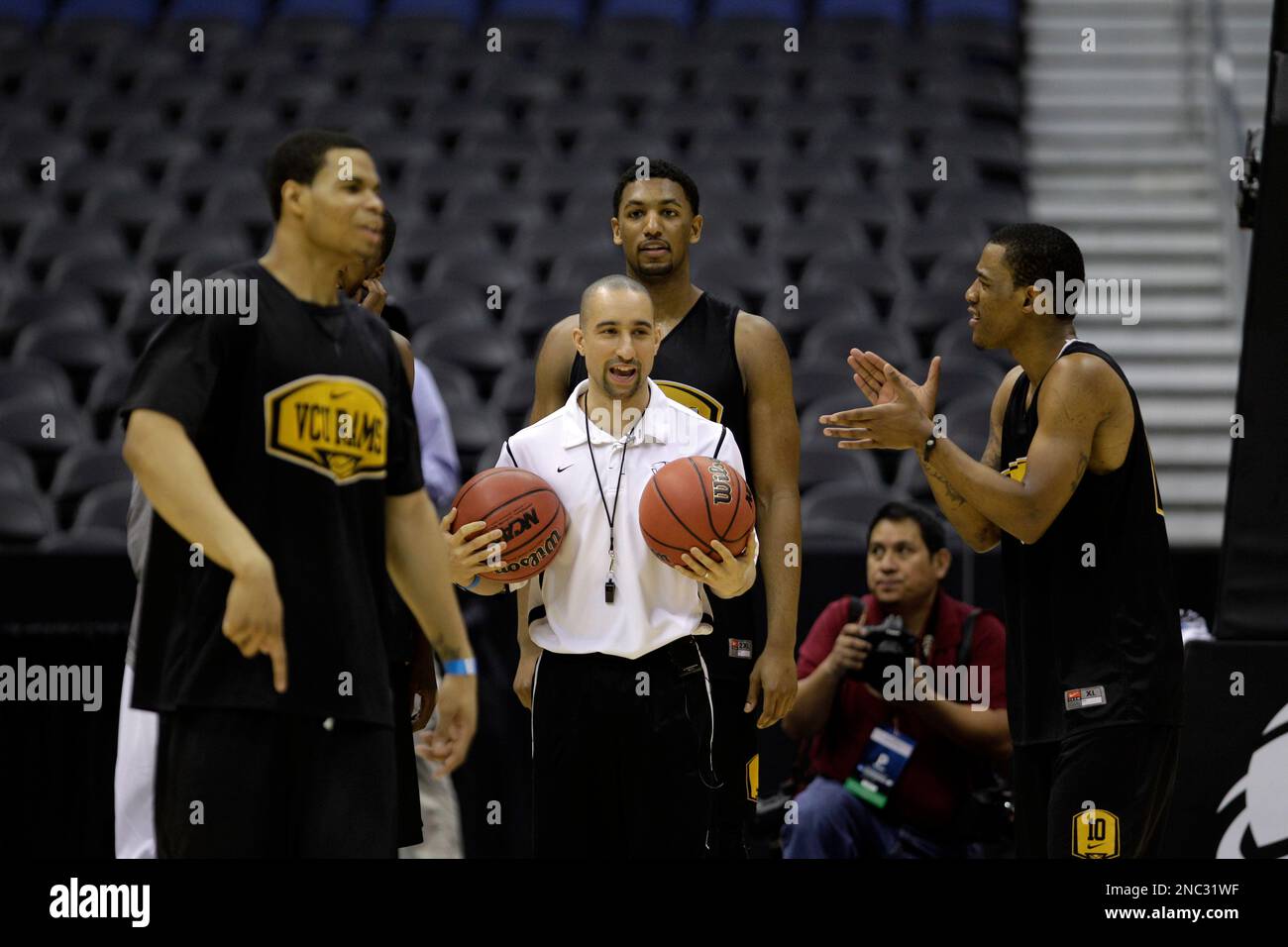 VCU head coach Shaka Smart talks with his team during a practice for a ...
