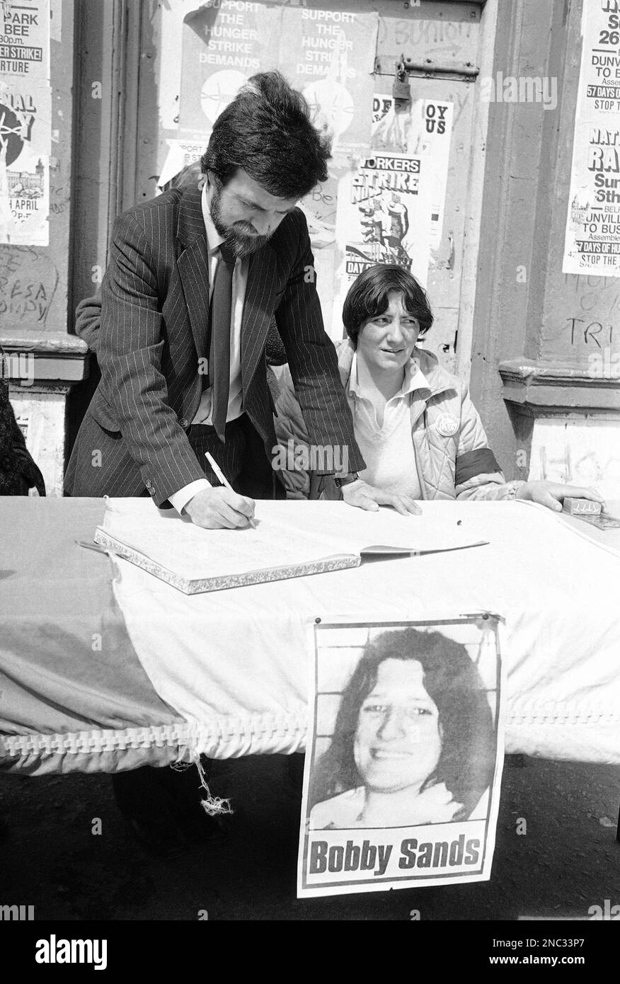 Local residents sign a condolence book for Bobby Sands, outside the ...