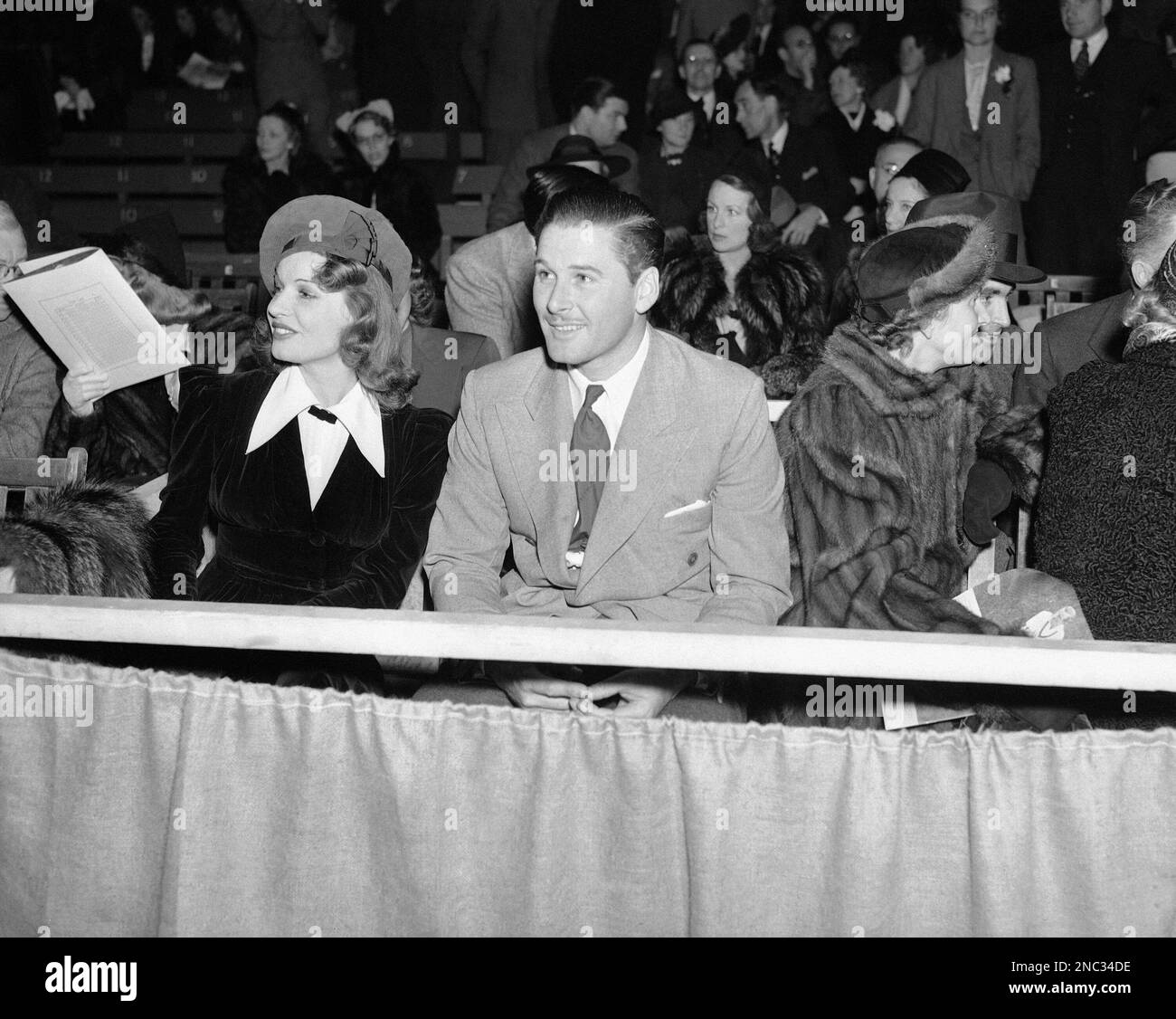 Australian actor Errol Flynn and his wife Lili Damita watch the tennis ...