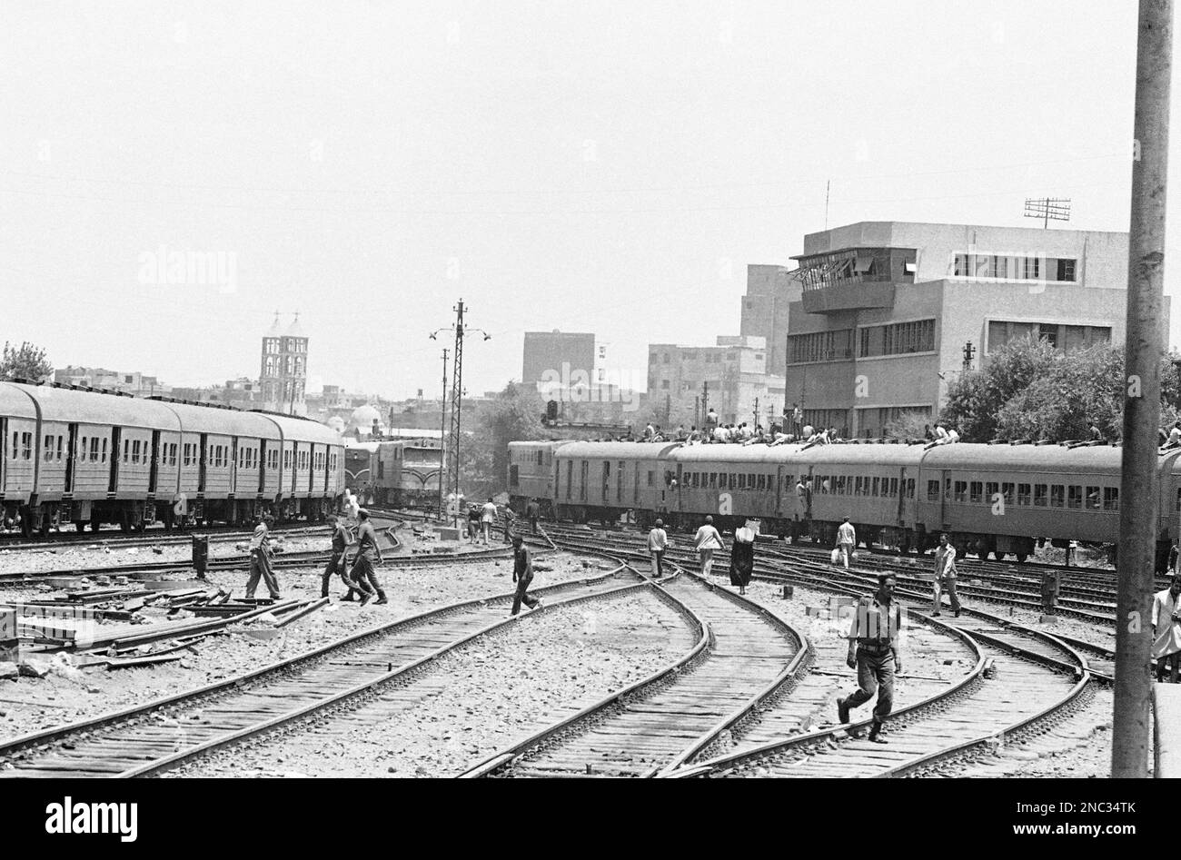 Passengers run for a train as it arrives in Rameses Station in Cairo on ...