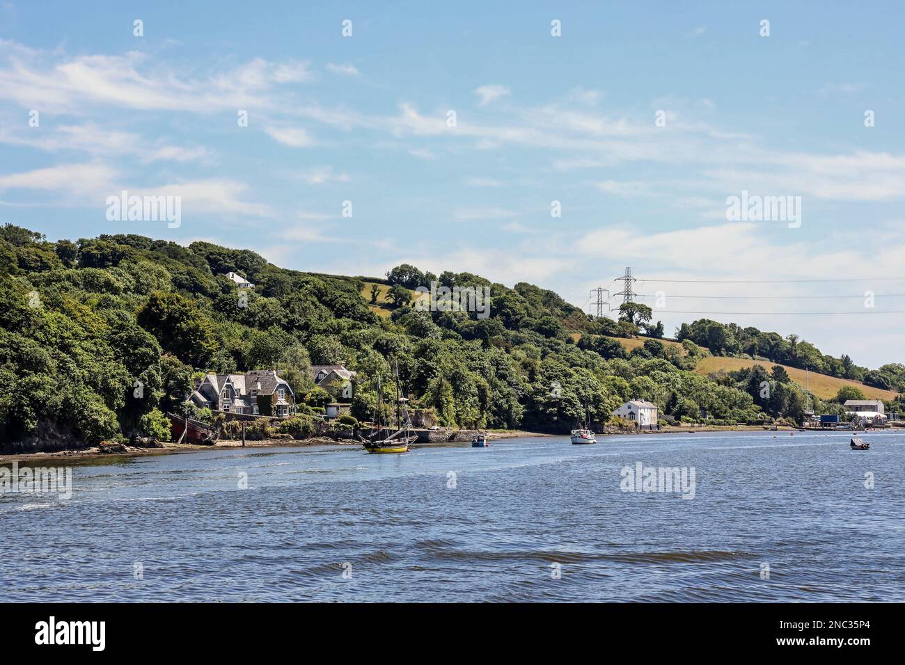 Stone house and yellow sailing boat a little up river from Weir Quay on ...