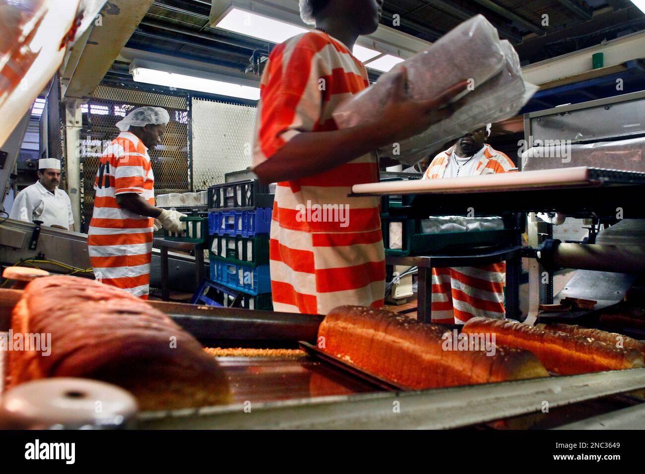 Inmates pack machine sliced and wrapped bread at the Rikers Island jail ...