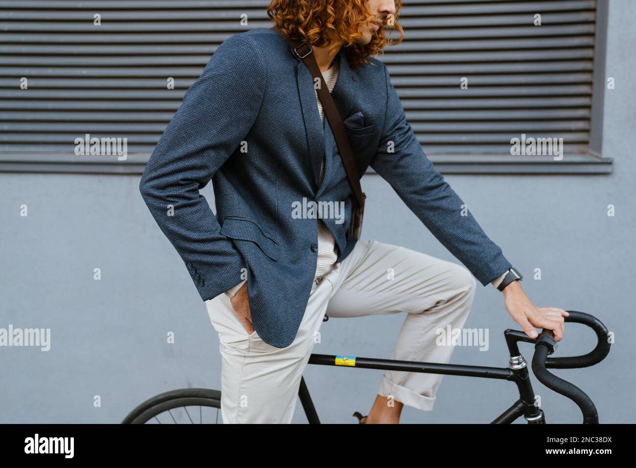 Ginger european man wearing jacket riding on bicycle at city street ...