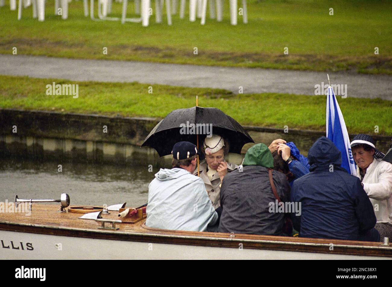 Britain’s Princess Anne shares a laugh with boatmen aboard the umpire’s ...