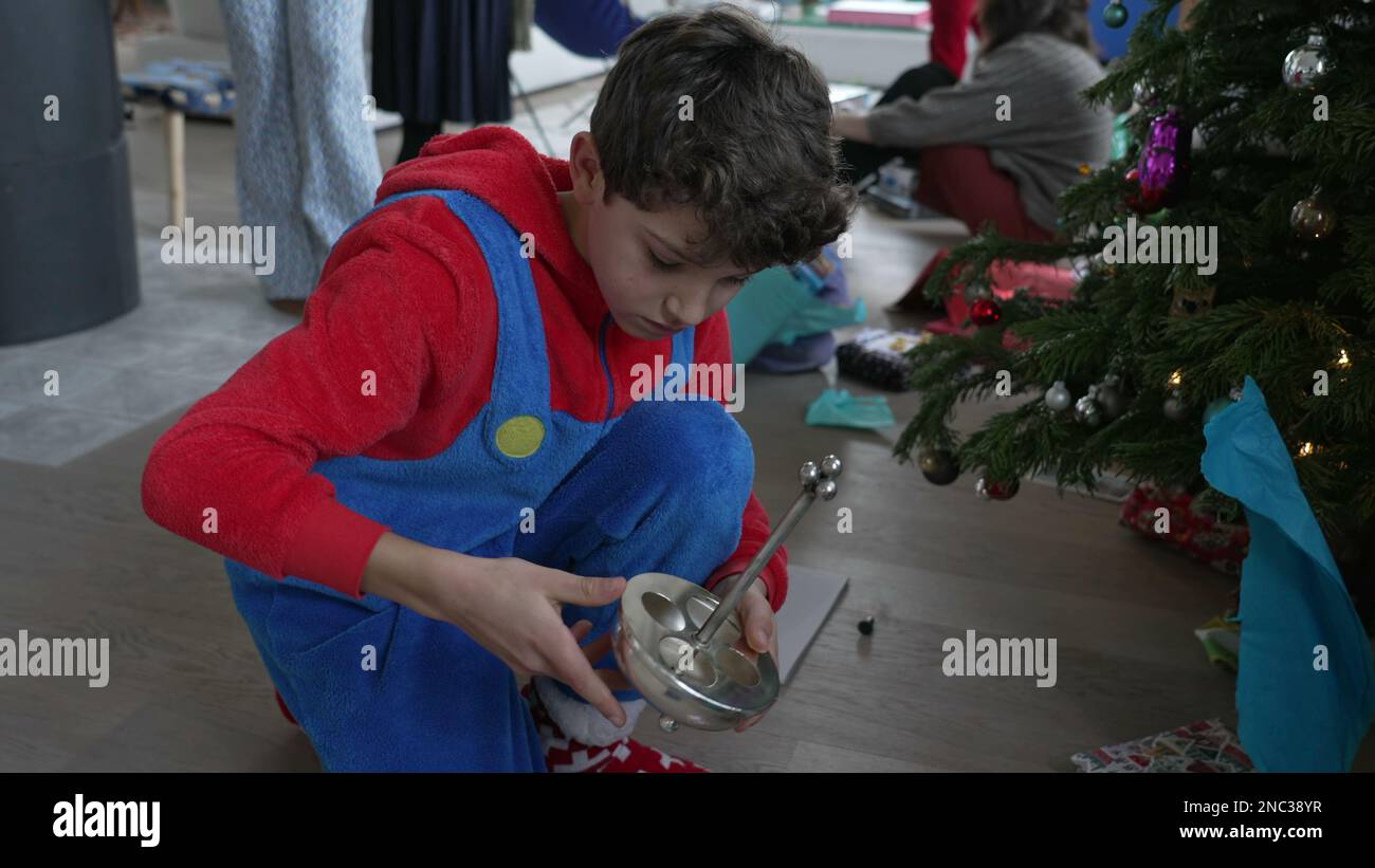Child unboxing present during Christmas morning day. Young box opening ...