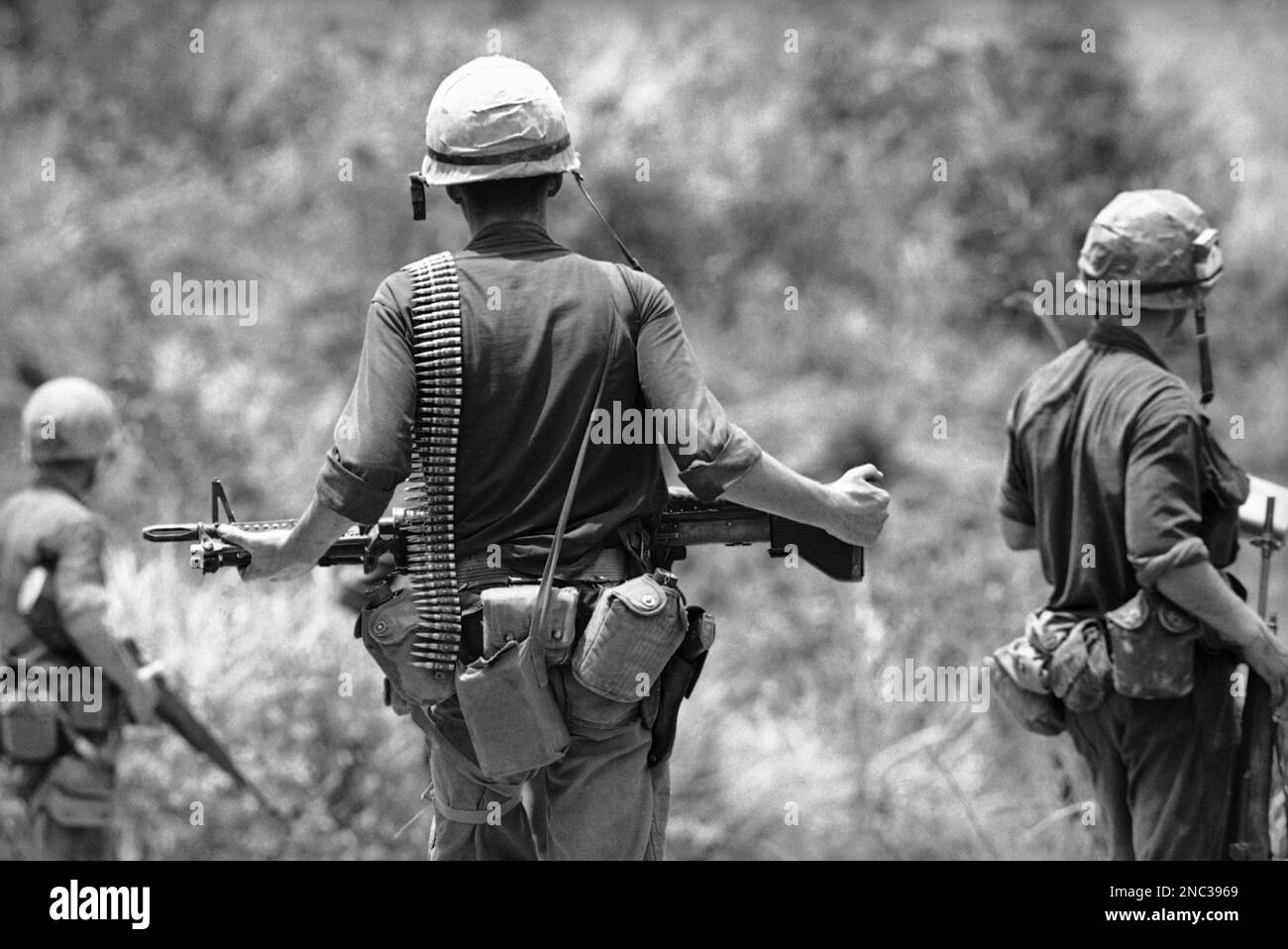 In pursuit of Red guerrillas U.S. Marine carries machine gun and ...