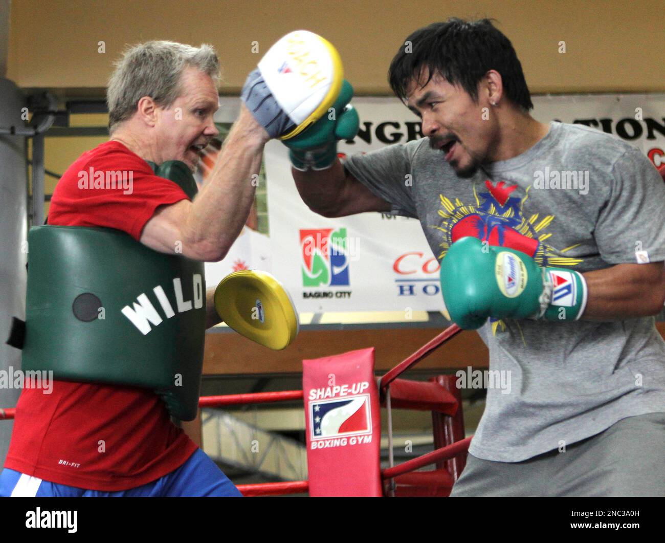Filipino world boxing champion Manny Pacquiao, right, trains with coach Freddie Roach for his ...