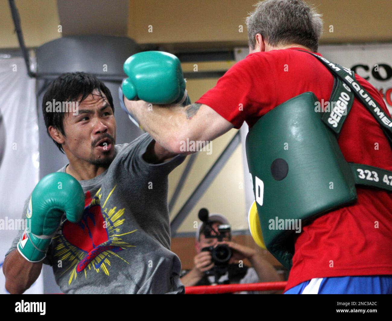 Filipino world boxing champion Manny Pacquiao, left, trains with coach ...