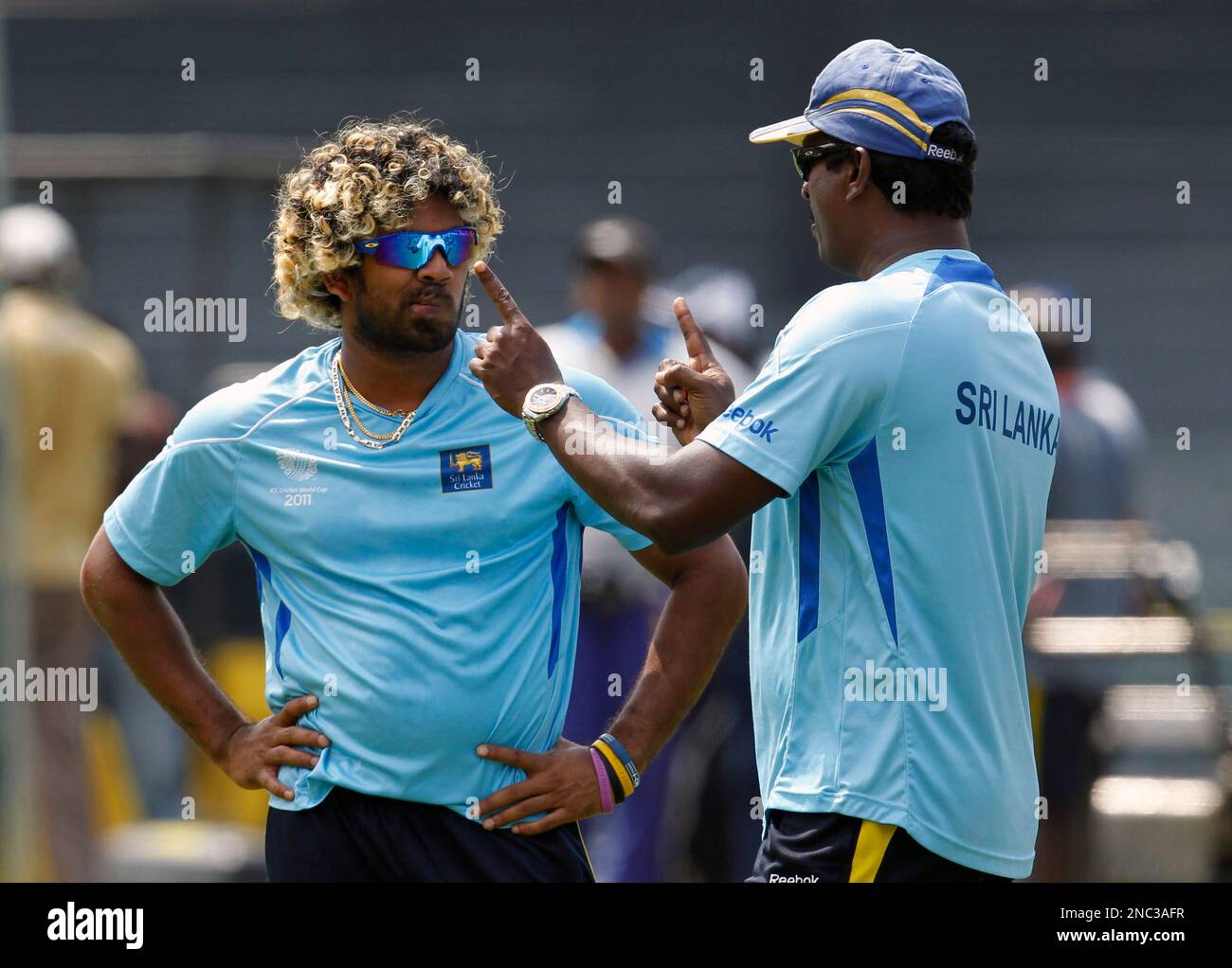 Sri Lankan bowler Lasith Malinga, left, listens to his bowling coach ...