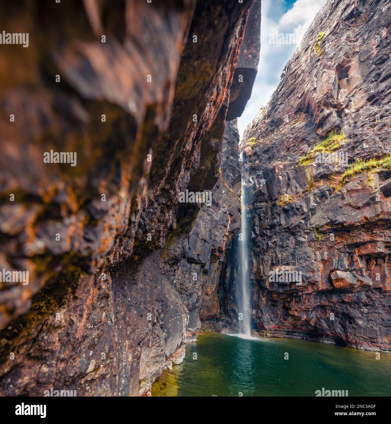 Gorgeous waterfall in outskirts of Haldarsvik village. Majestic summer ...