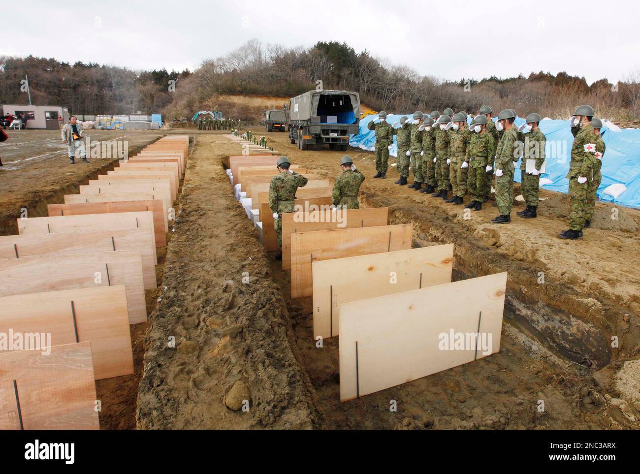 Japan Ground Self Defense Force salute after laying a coffin during a ...