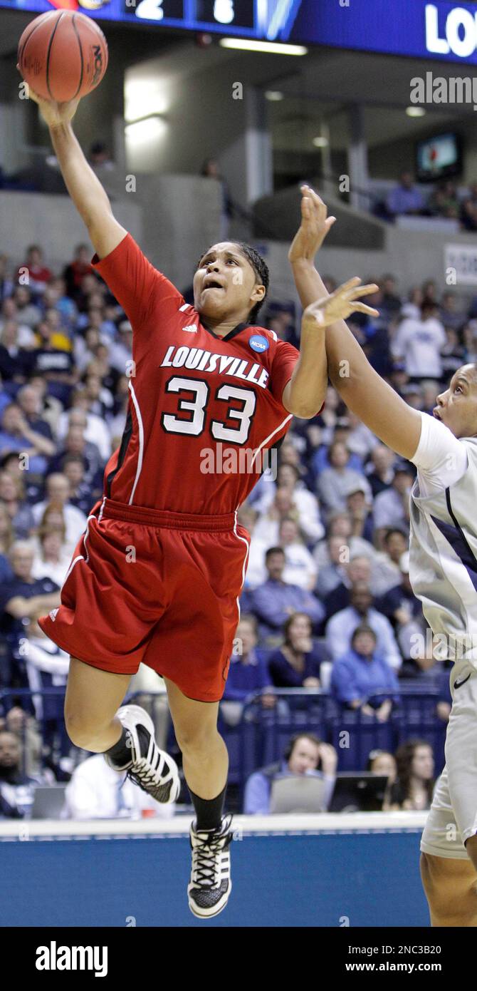 Louisville forward Monique Reid (33) drives past Xavier center Ta'Shia ...