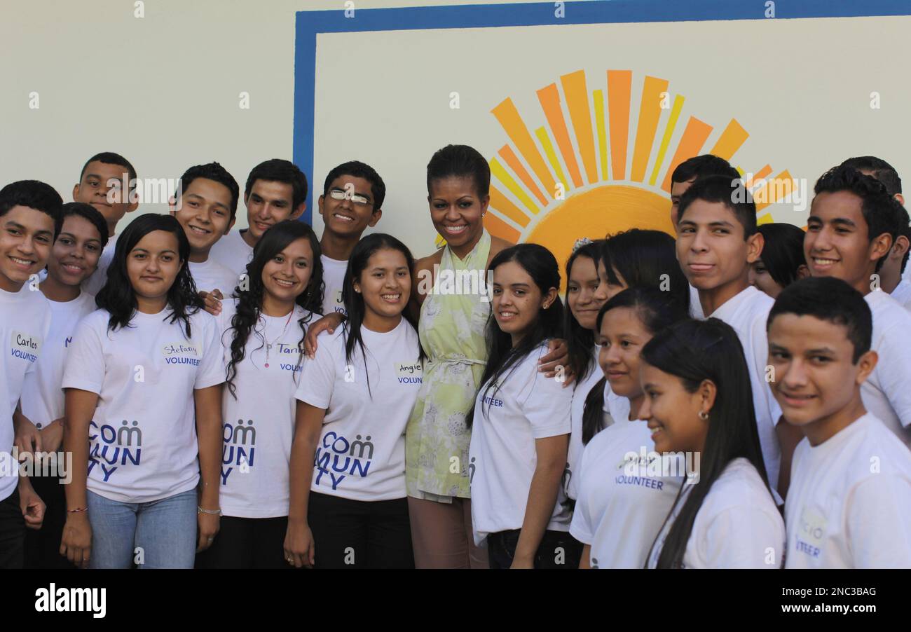 First lady Michelle Obama poses with young students after helping them ...