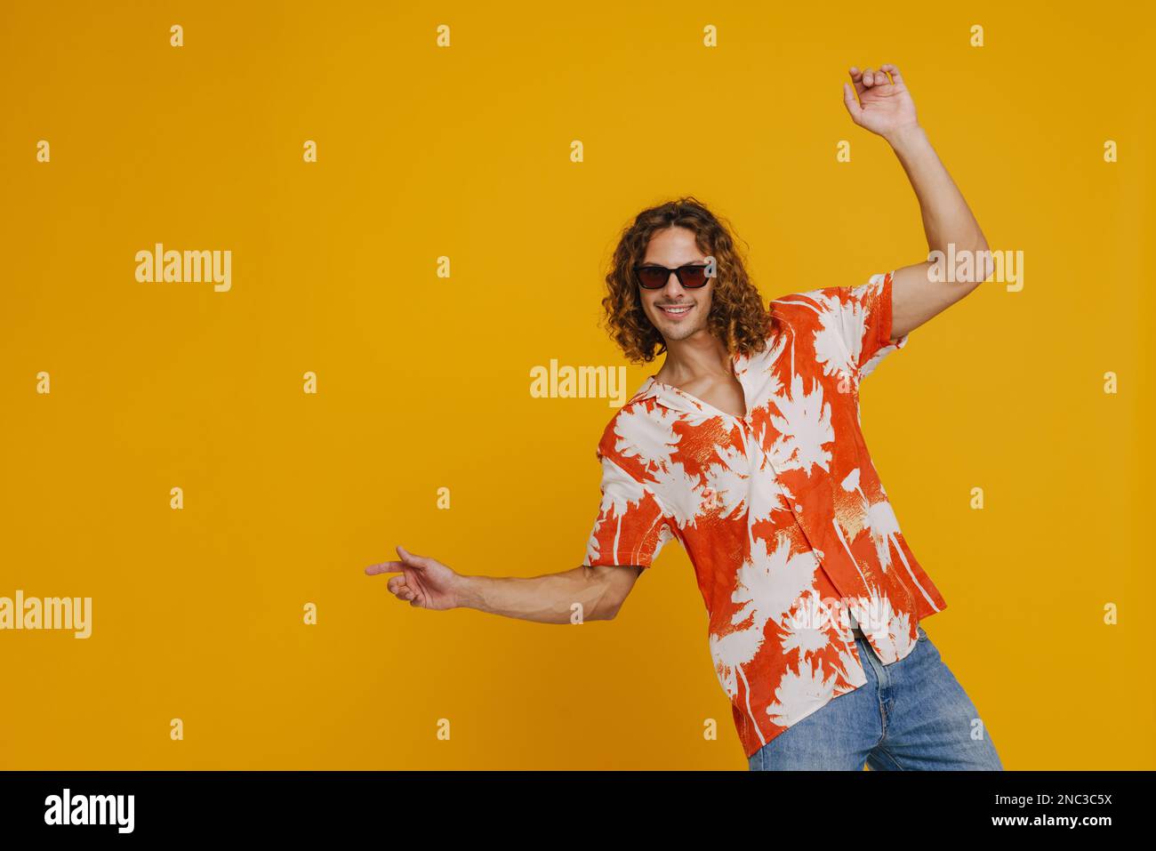 Ginger european man in sunglasses smiling and dancing isolated over ...