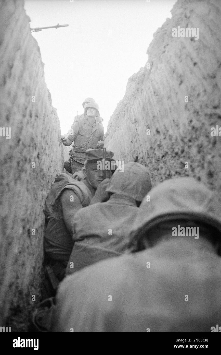 U.S. Marines huddle in trench beside Air Terminal Building at Dong Ha ...
