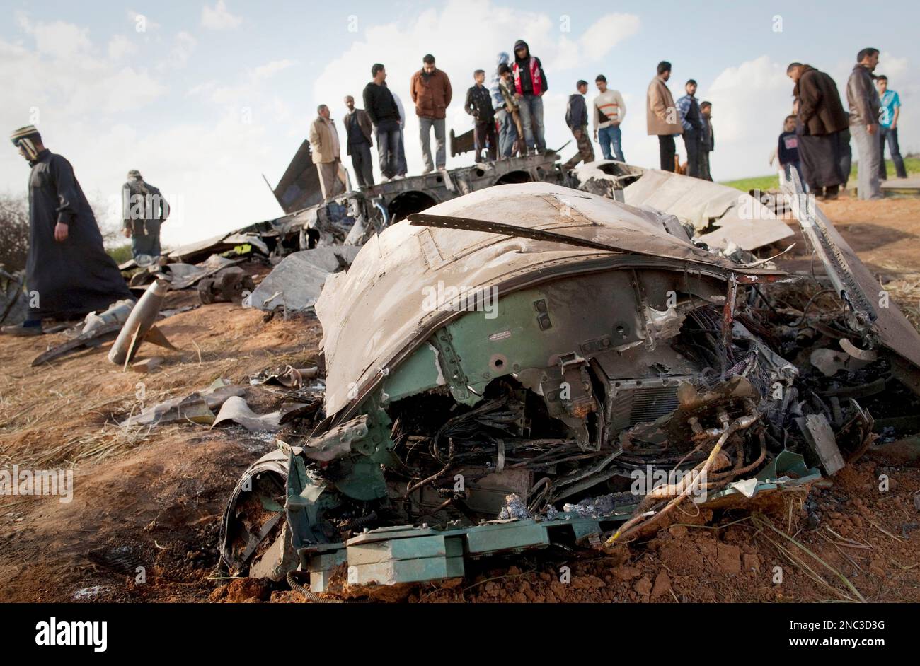 Libyans inspect the wreckage of a US F15 fighter jet after it crashed ...
