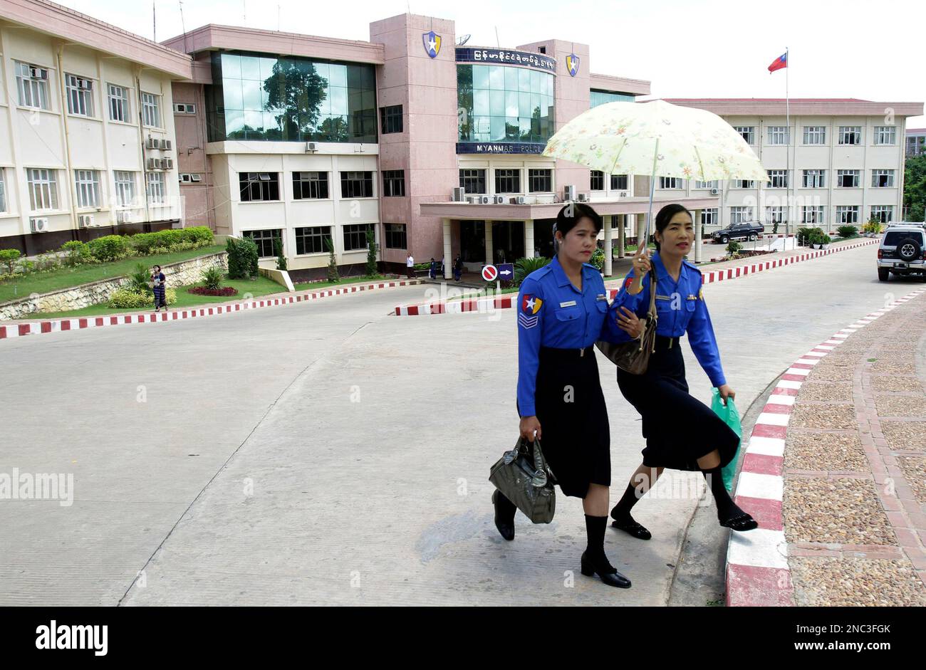 In this photo taken June 26, 2010, two Myanmar policewomen walk outside ...