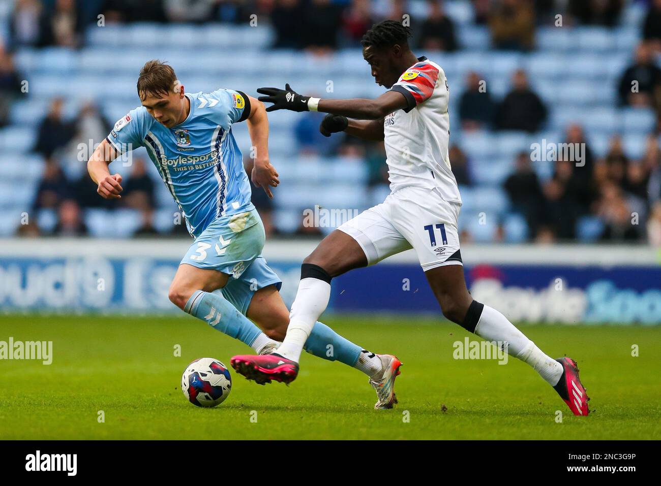 Coventry City's Callum Doyle and Luton Town's Elijah Adebayo battle for ...