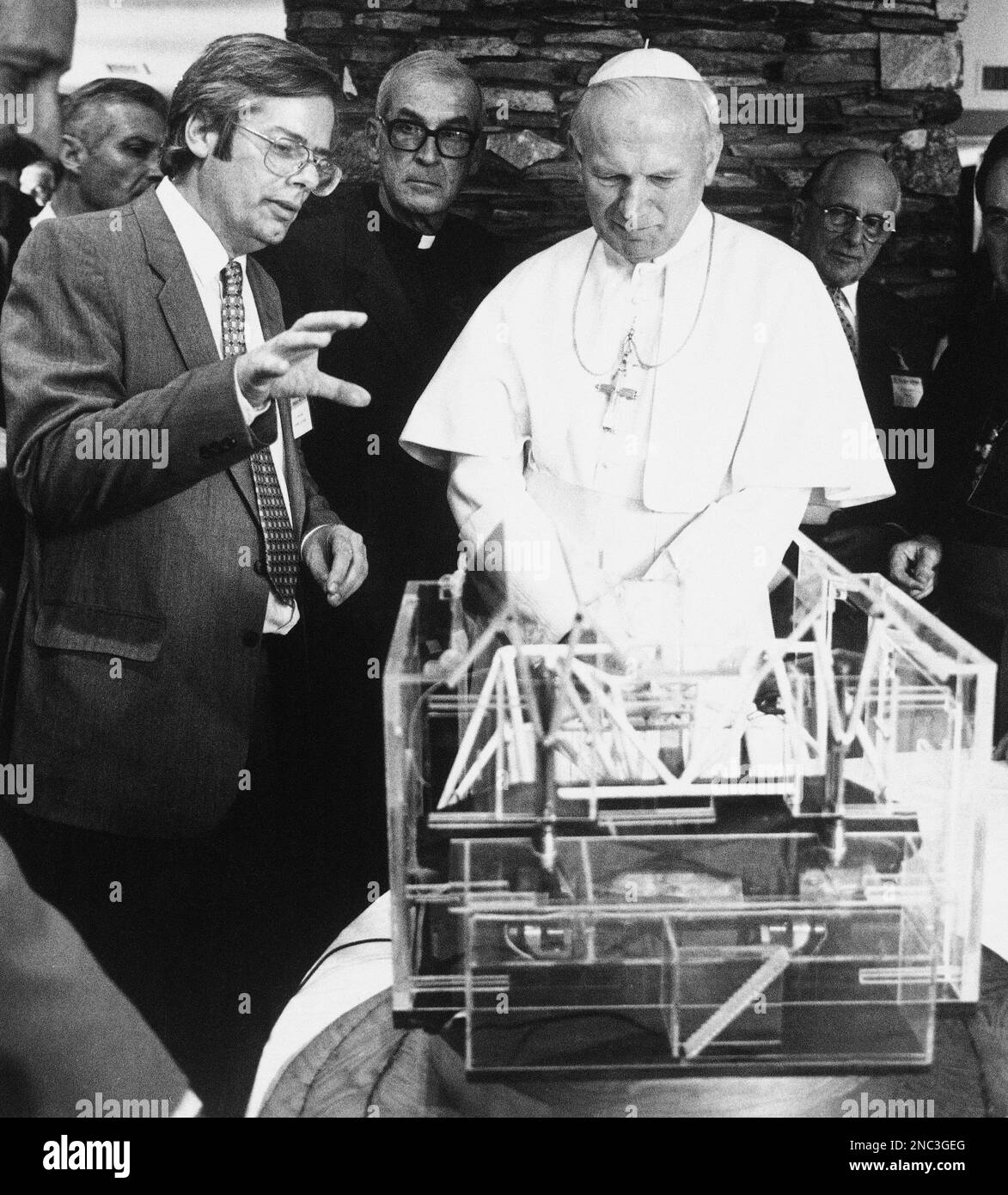 Pope John Paul II hears an explanation and sees a model of a twin ...