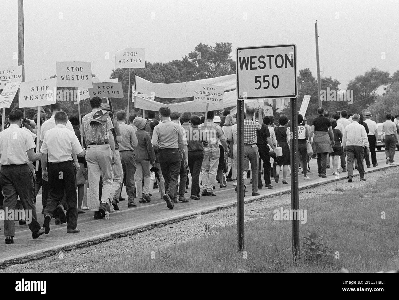 Walking holding placard western script protest Black and White Stock ...