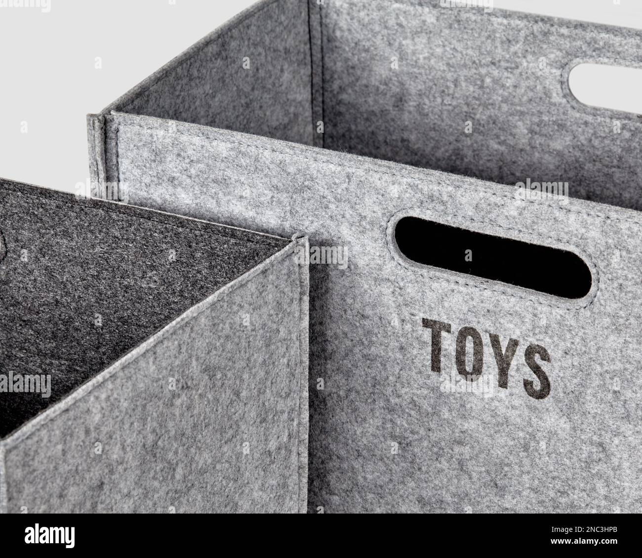 Gray felt boxes for storing toys with handles Stock Photo - Alamy