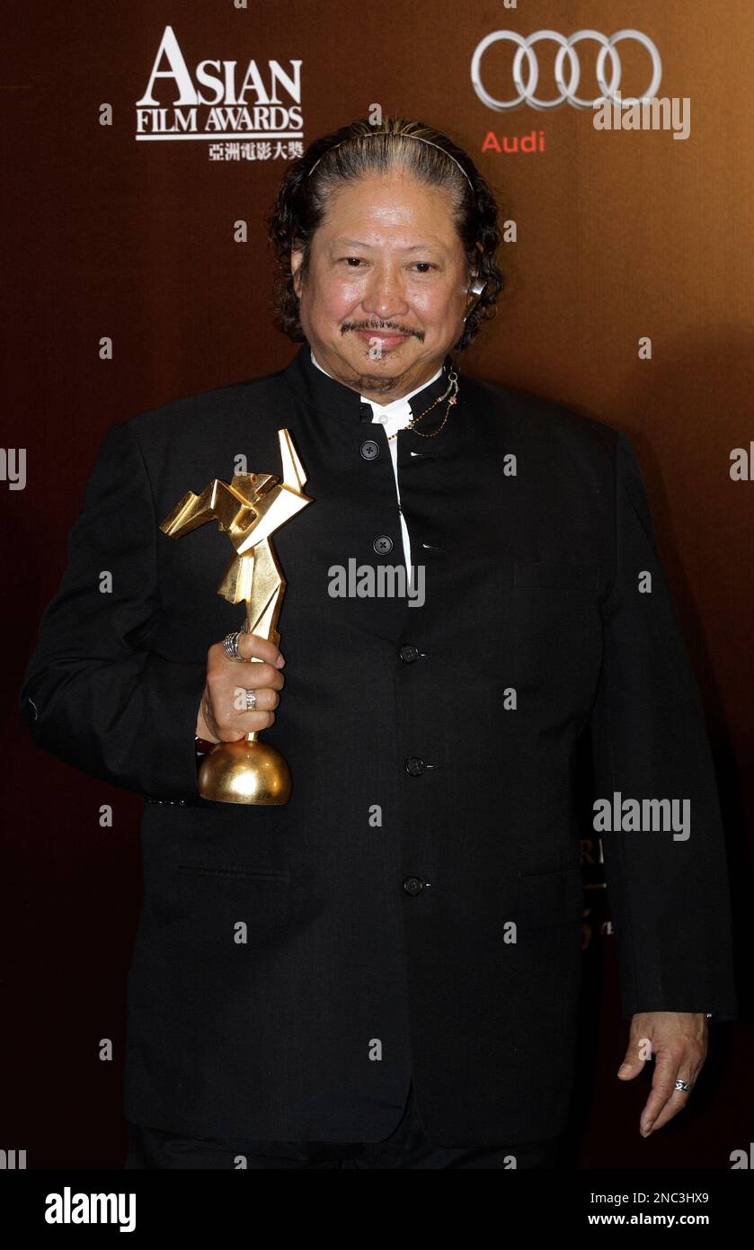 Hong Kong actor-director Sammo Hung Kam-po poses with the trophy after ...