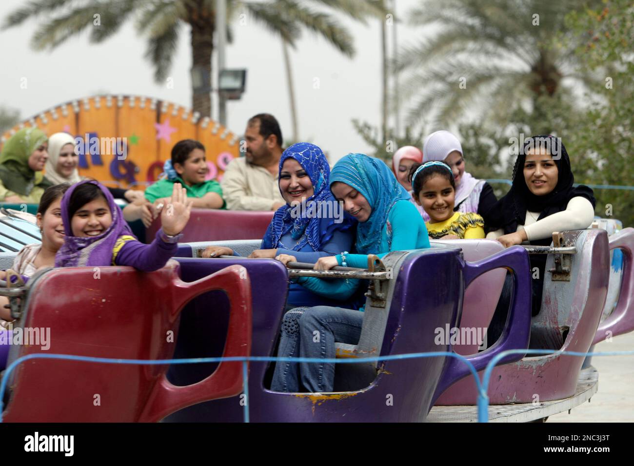 Iraqi girls are seen on a carnival ride during a celebration of Nowruz ...