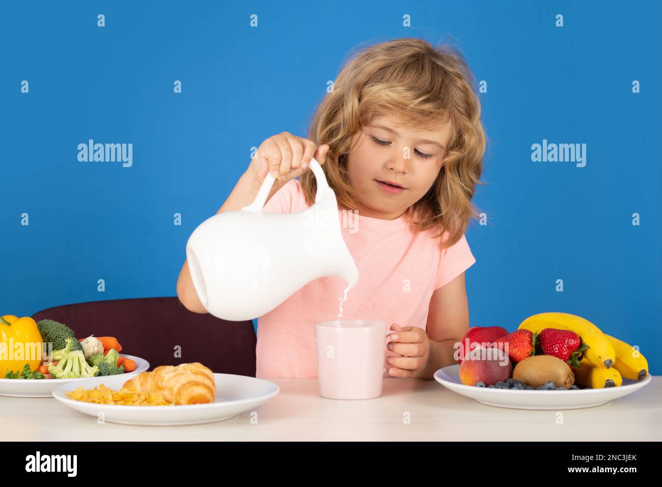 Child drink dairy milk. Kid boy pouring whole cows milk. Portrait of ...