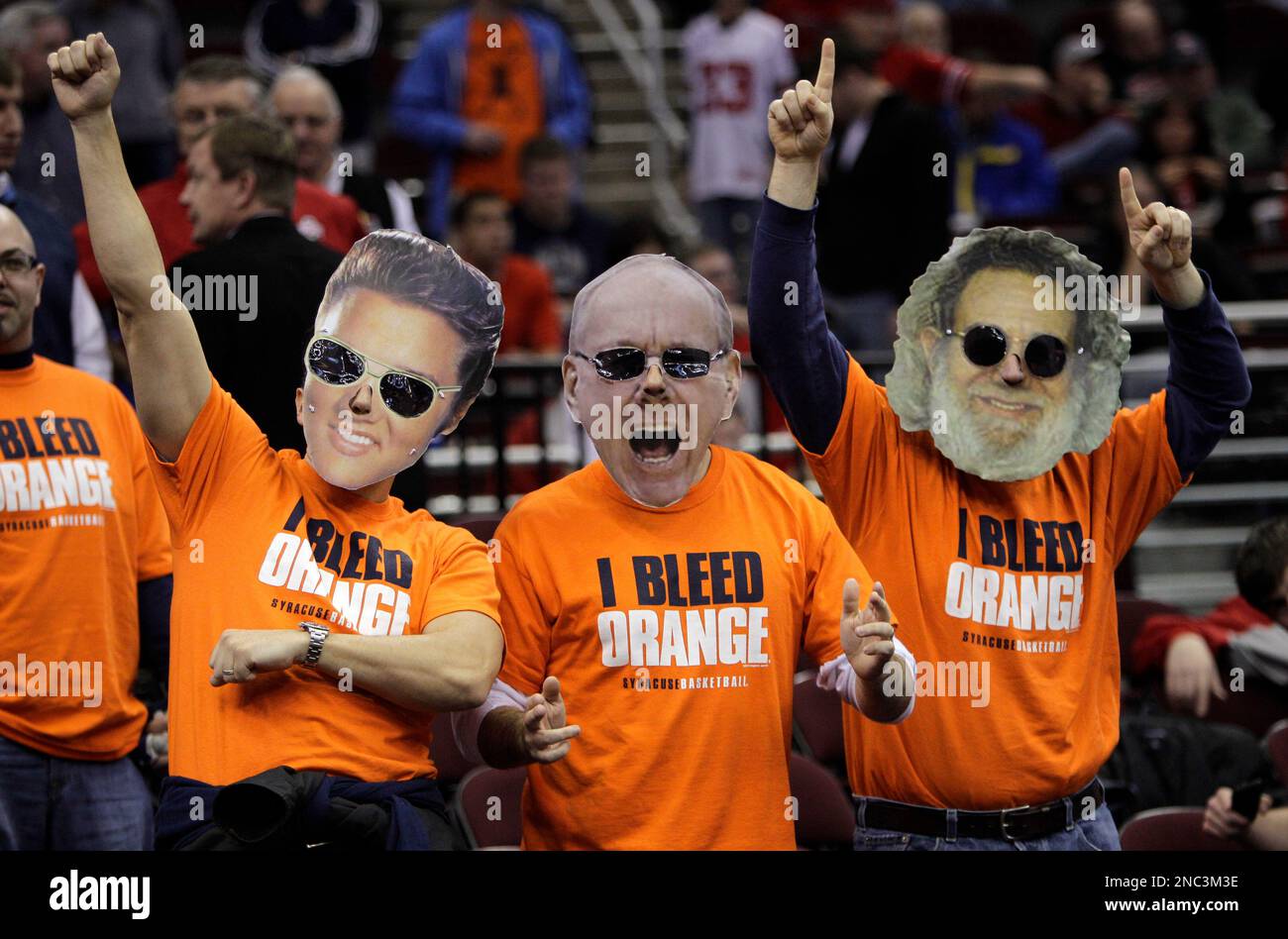 Fans Chris Groat, left, John Groat, and Denis Hickey, wears masks of ...