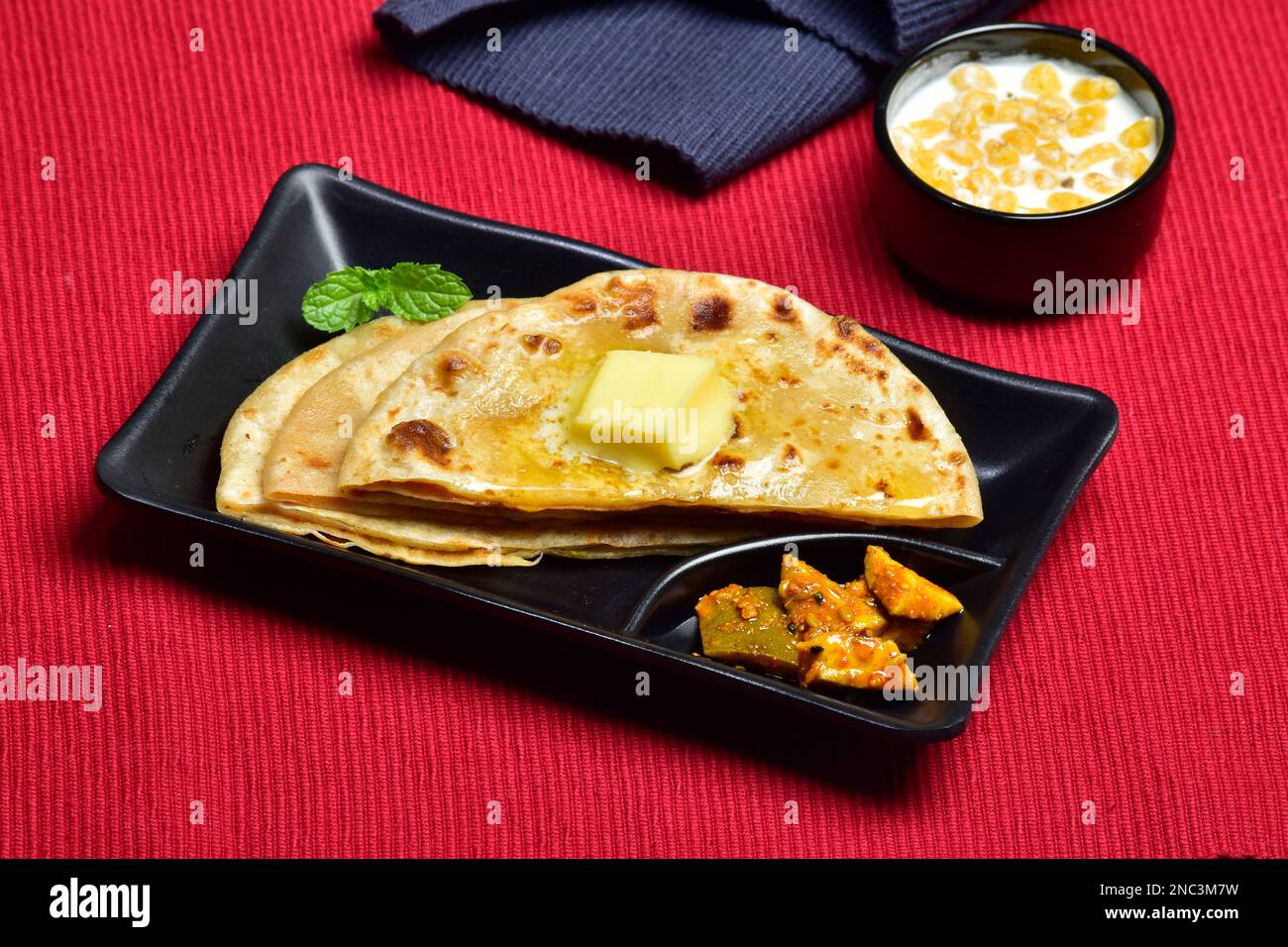 Butter stuffed paratha served with raita, healthy indian breakfast ...