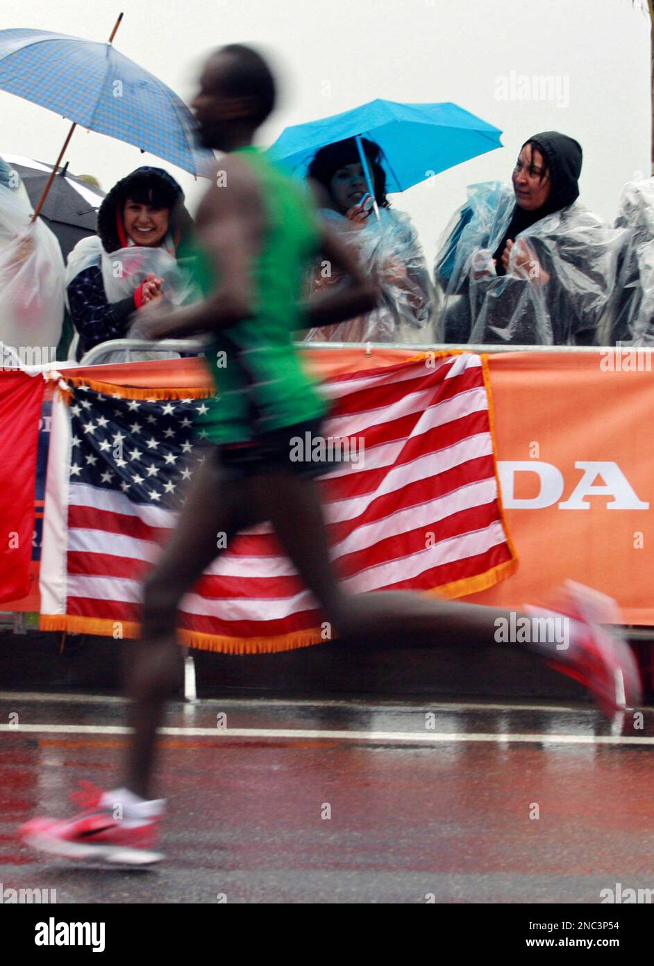 People clap as a runner races at the Honda LA Marathon in Santa Monica ...