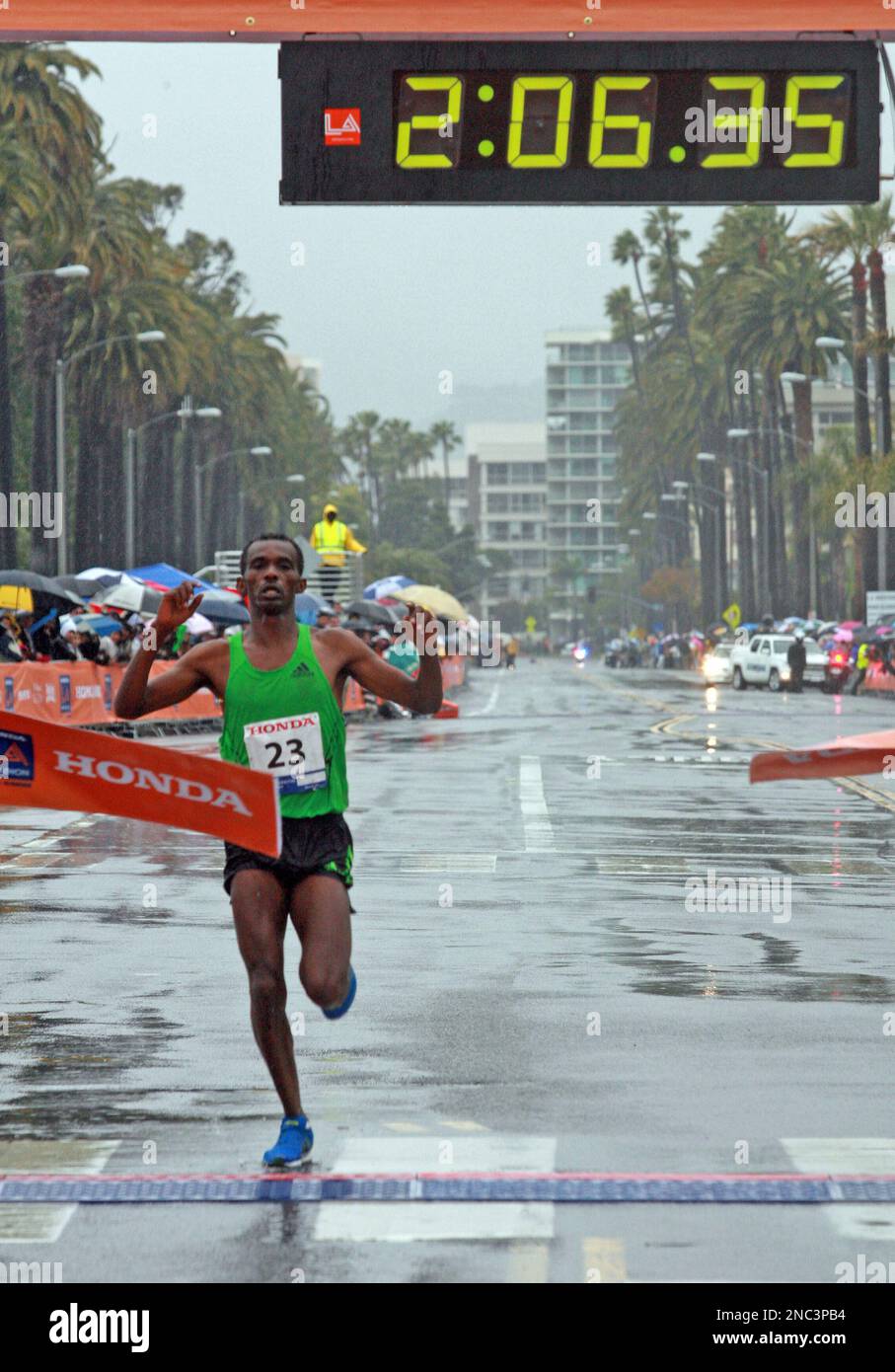 Runner Markos Geneti crosses the finish line to win the Honda LA ...