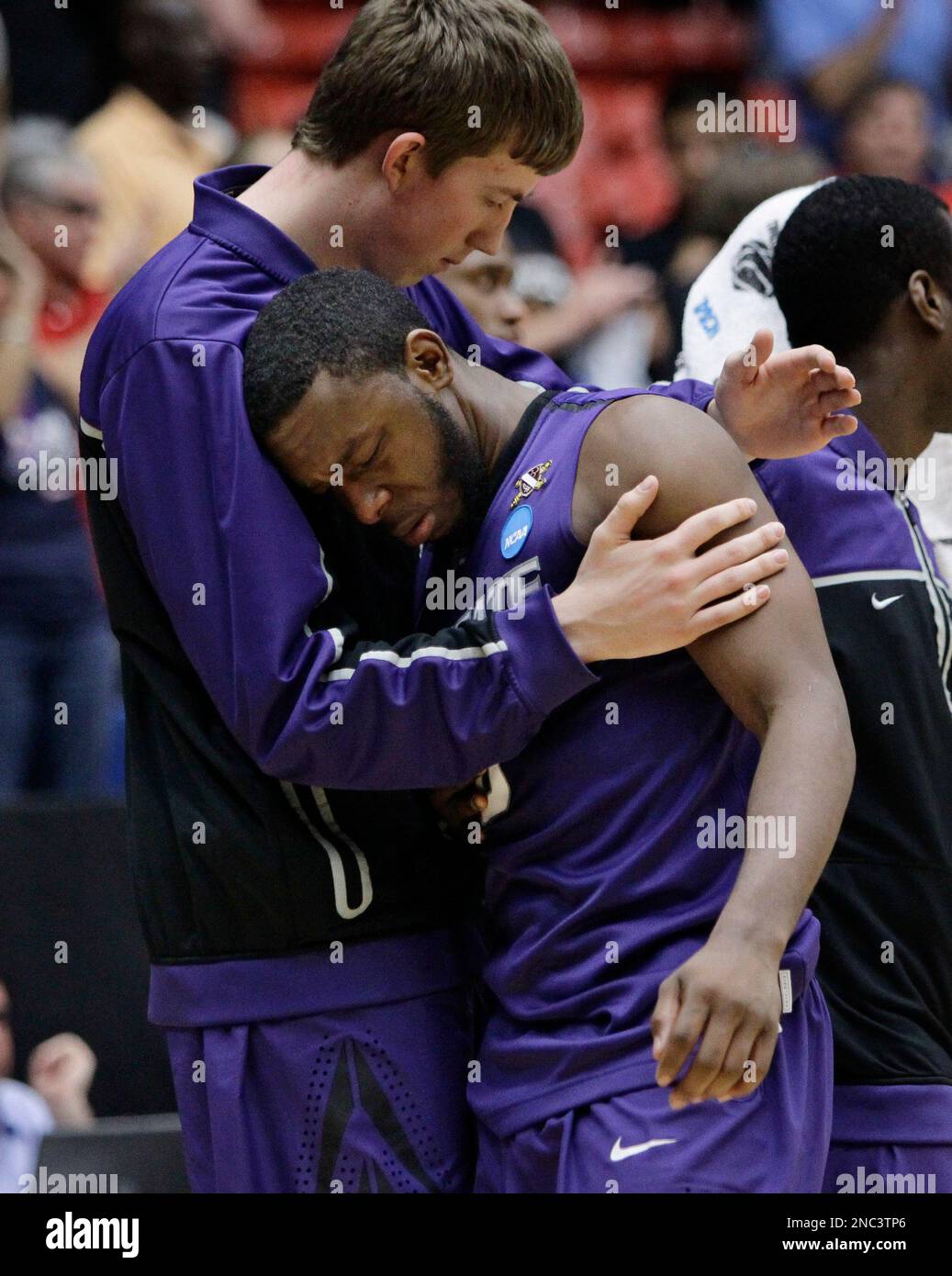 Kansas State's Jacob Pullen, center, is consoled by teammate Alex ...