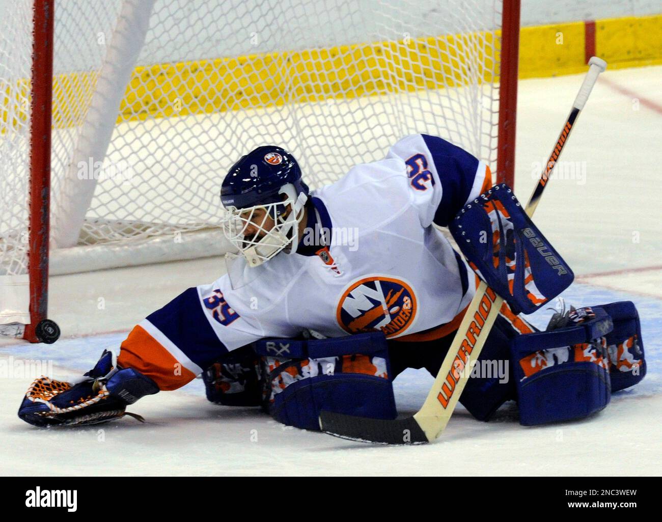 New York Islanders goalie Rick DiPietro Steers aside one of eight ...