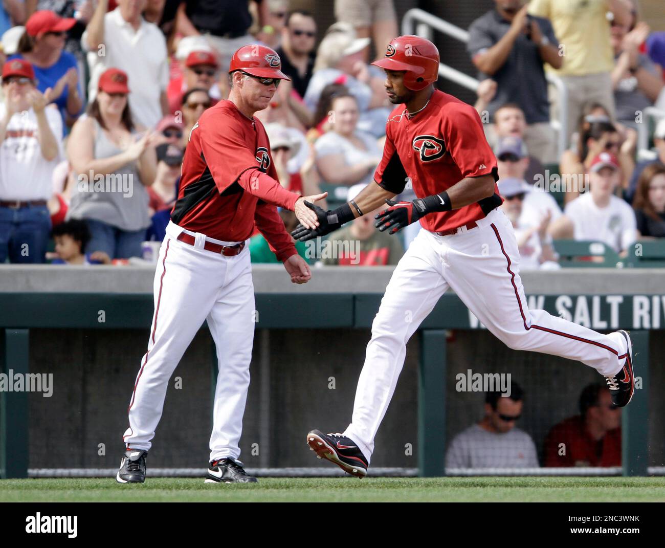 Arizona Diamondbacks' Chris Young, right, is greeted by third base ...
