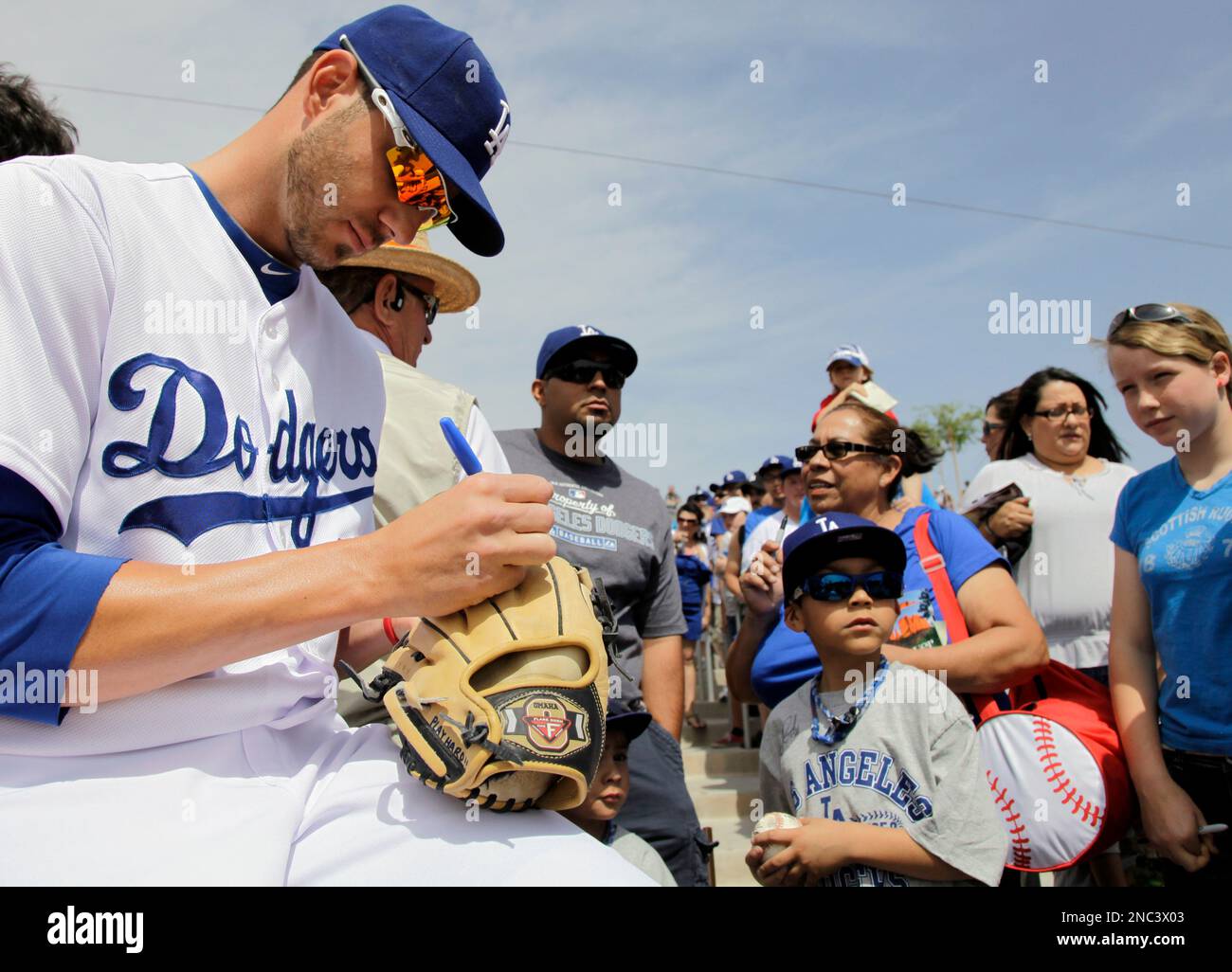 Los Angeles Dodgers pitcher John Garland, left, signs autographs before ...