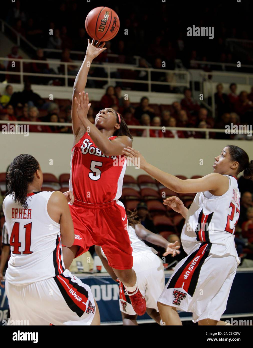 St. John's guard Nadirah McKenith (5) drives to the basket in front of ...