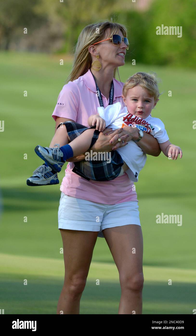 Kate Rose, wife of golfer Justin Rose, carries their son Leo off of the ...