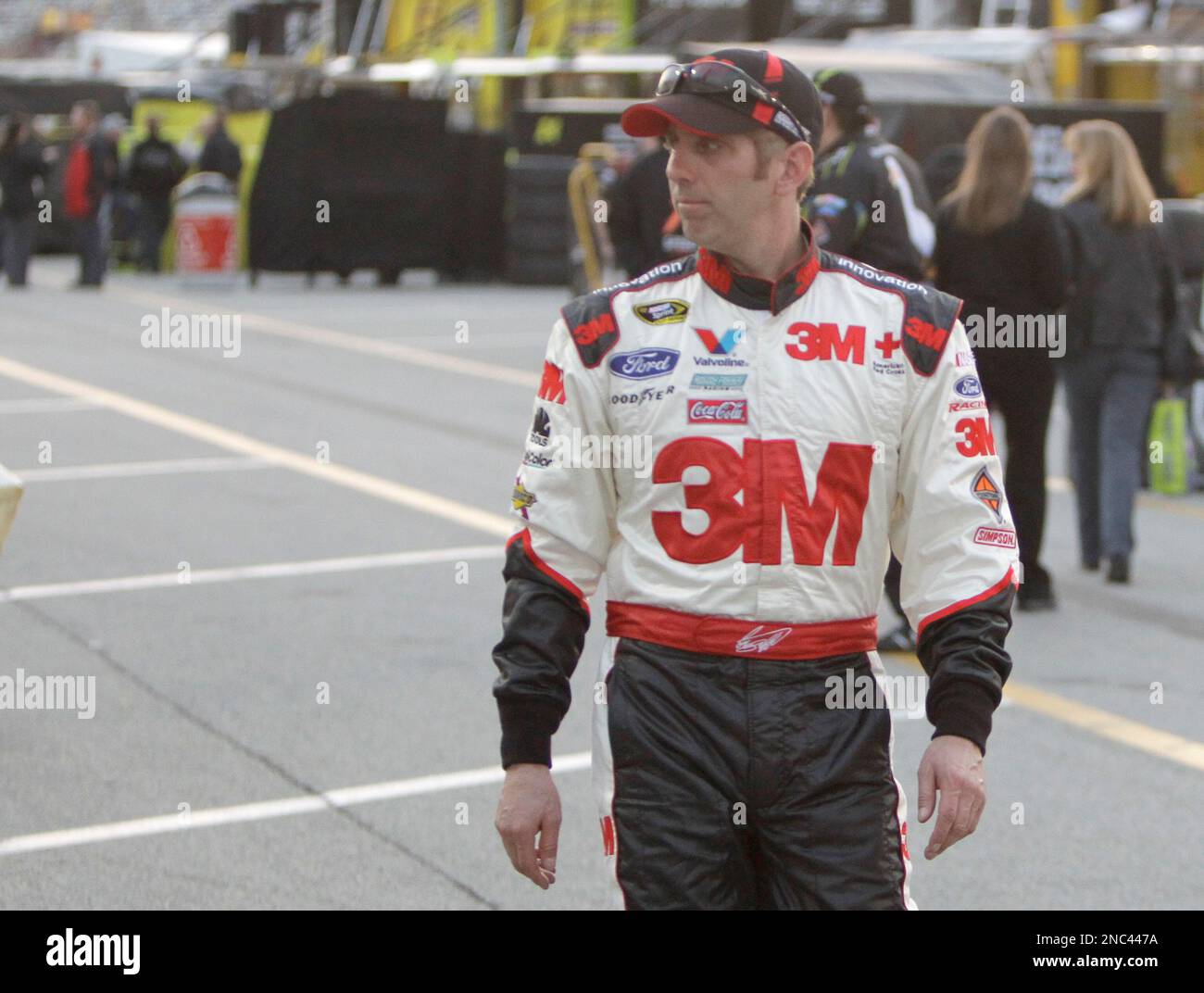NASCAR driver Greg Biffle walks along the garage area during auto ...