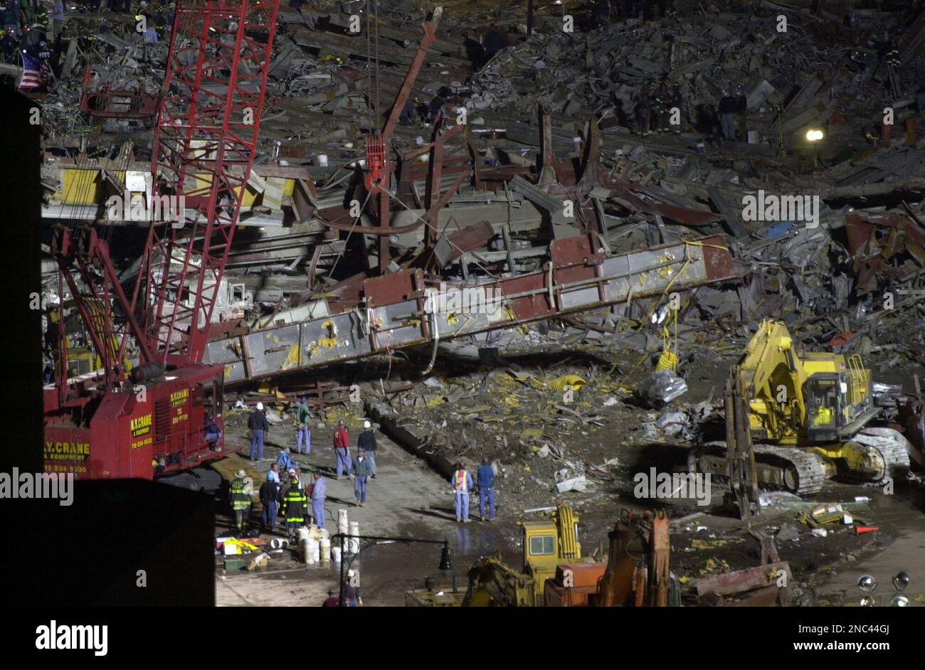 Construction workers continue to clear the rubble at the site of the ...
