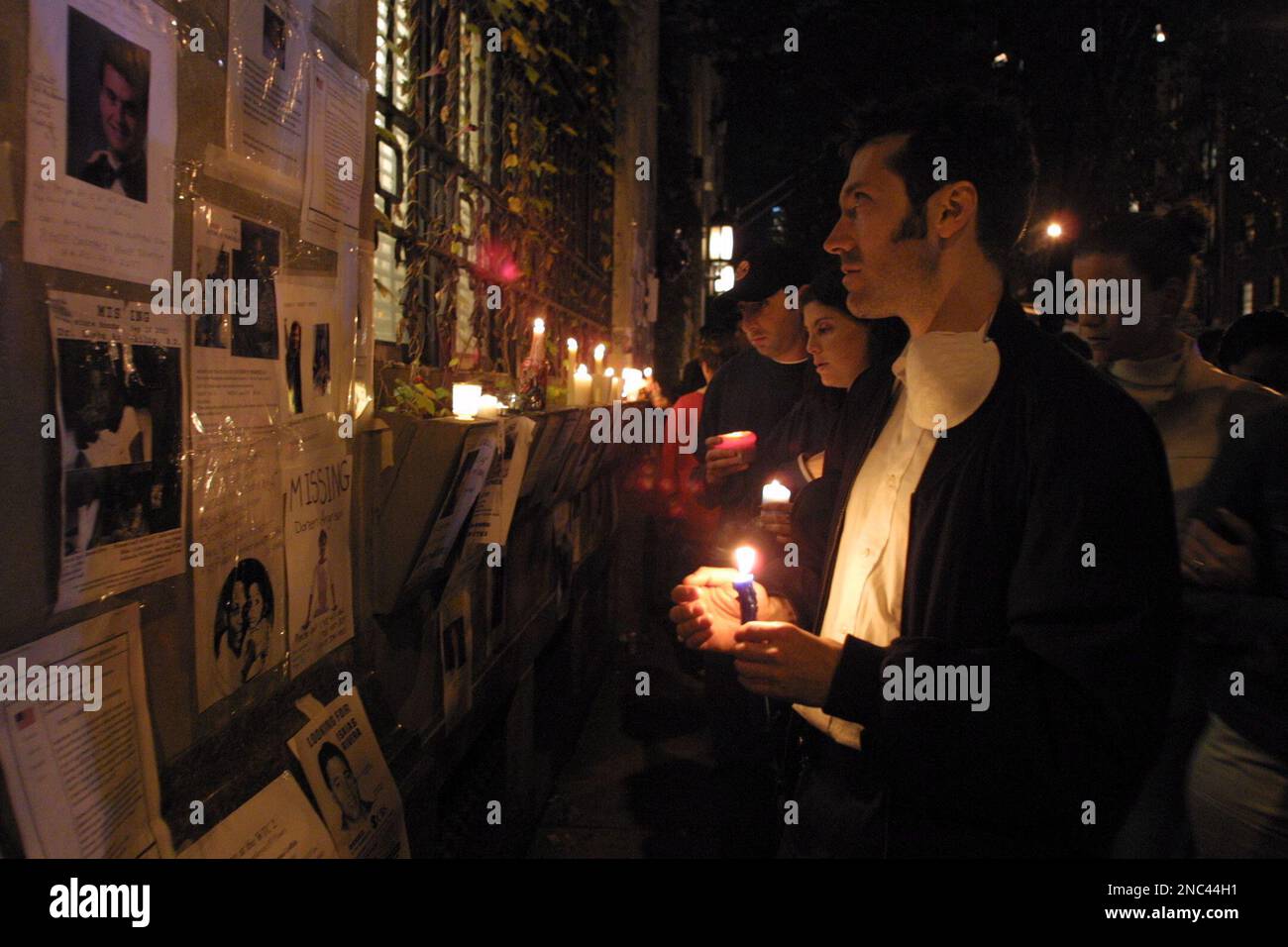 In this September 14, 2001 photograph, a man hold a candles and looks ...