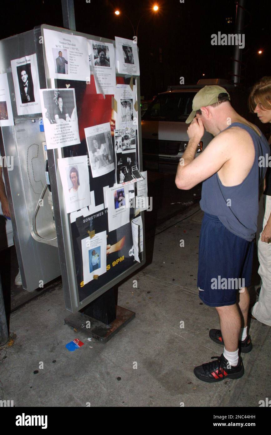 In this September 13, 2001 photograph, a man looks at missing person ...