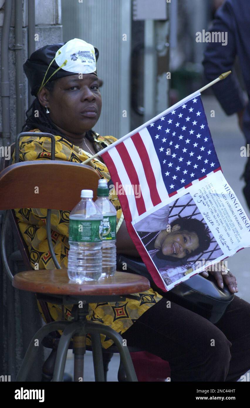 A woman has a flag with a missing person poster attached to it on Sept ...