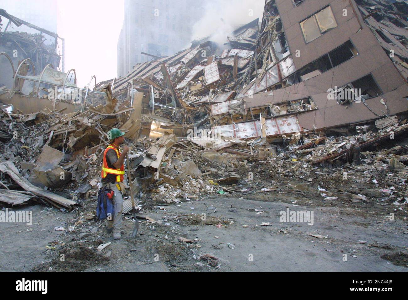In this September 14, 2001 photograph, a worker observes the rubble at ...
