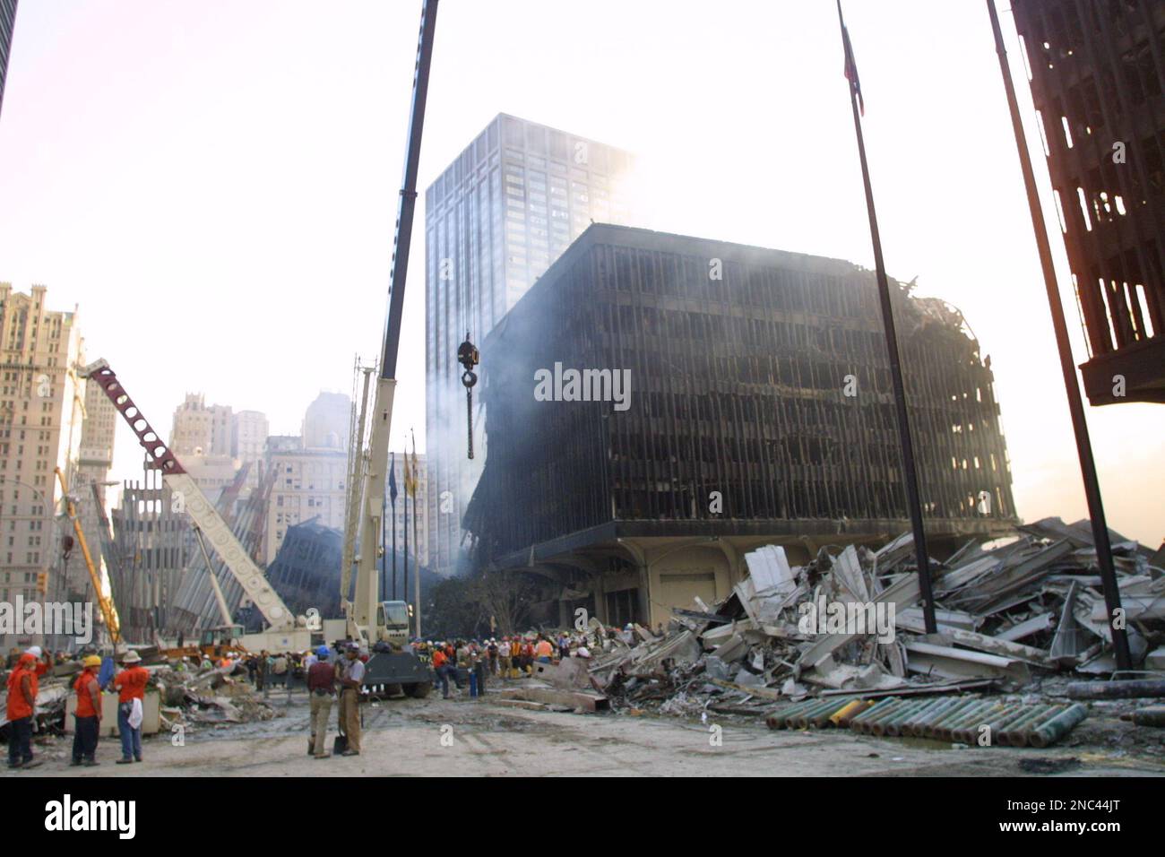 Construction workers survey the damage near ground zero after the ...