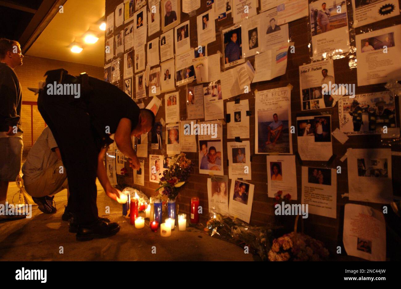 People light candles at a memorial for the victims of the September 11 ...